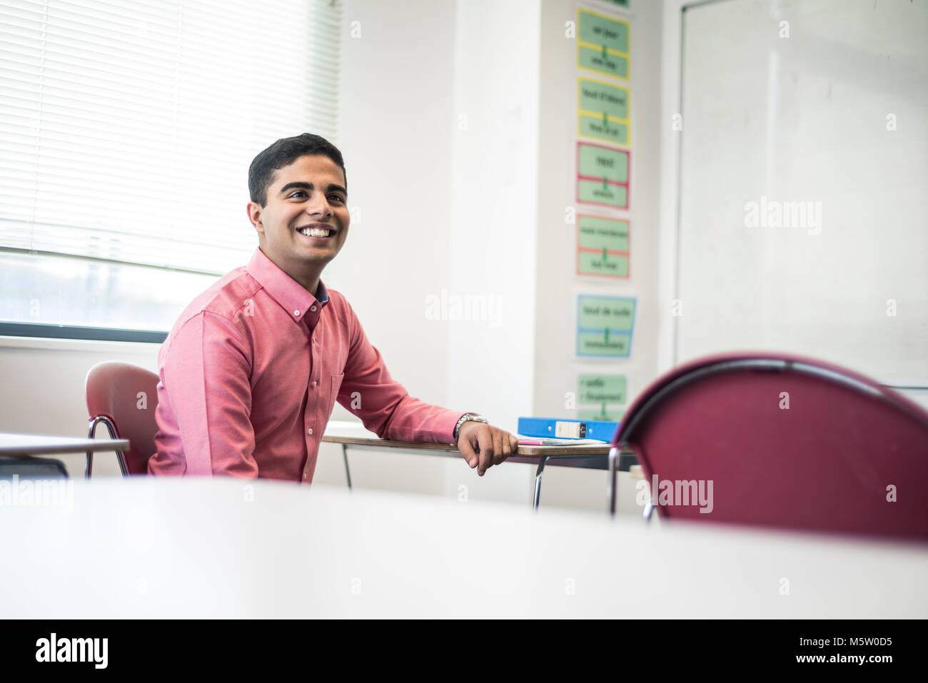 an indian male student sits on the classroom of an english university ...