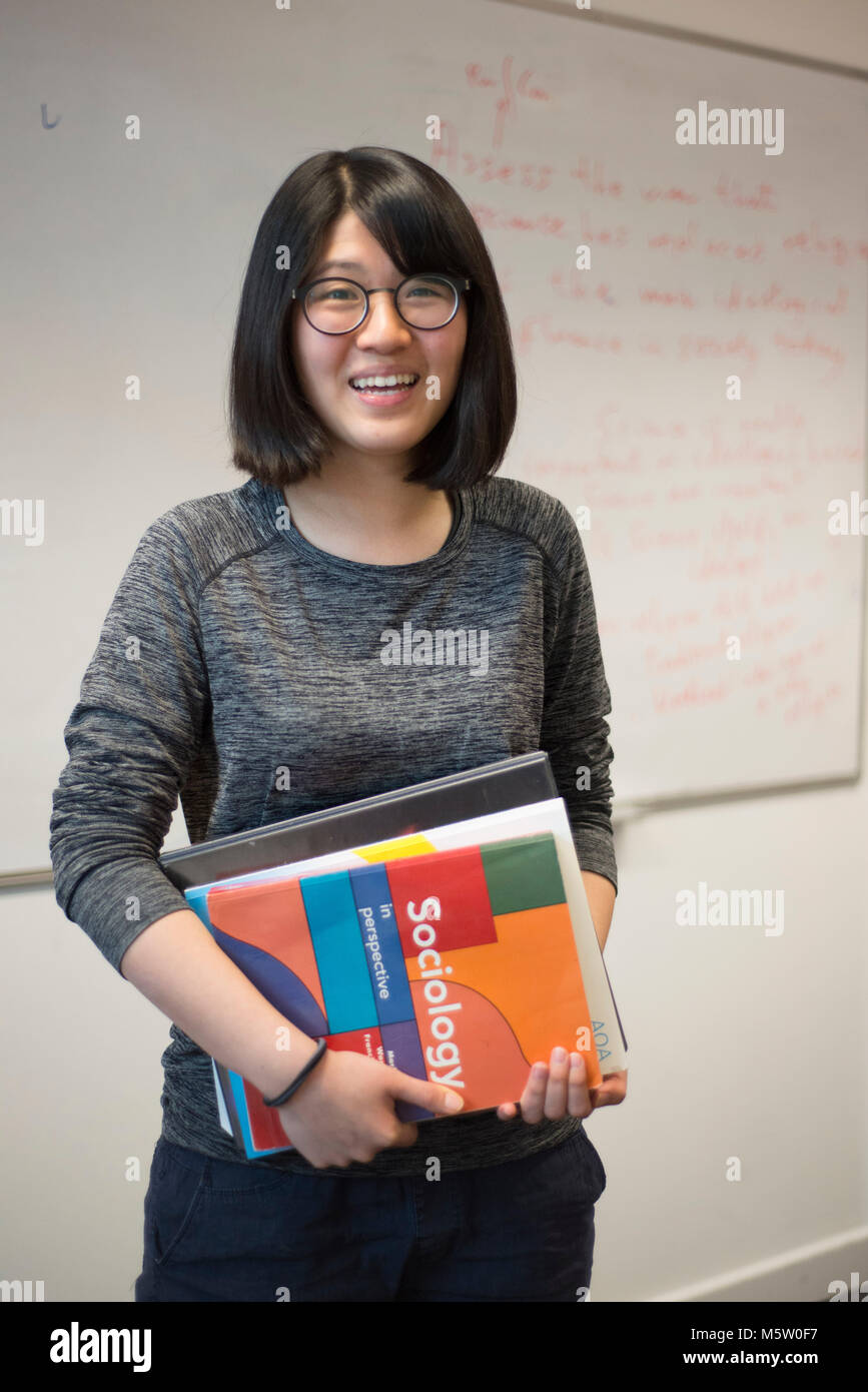a young international asian english student in her classroom at college ...