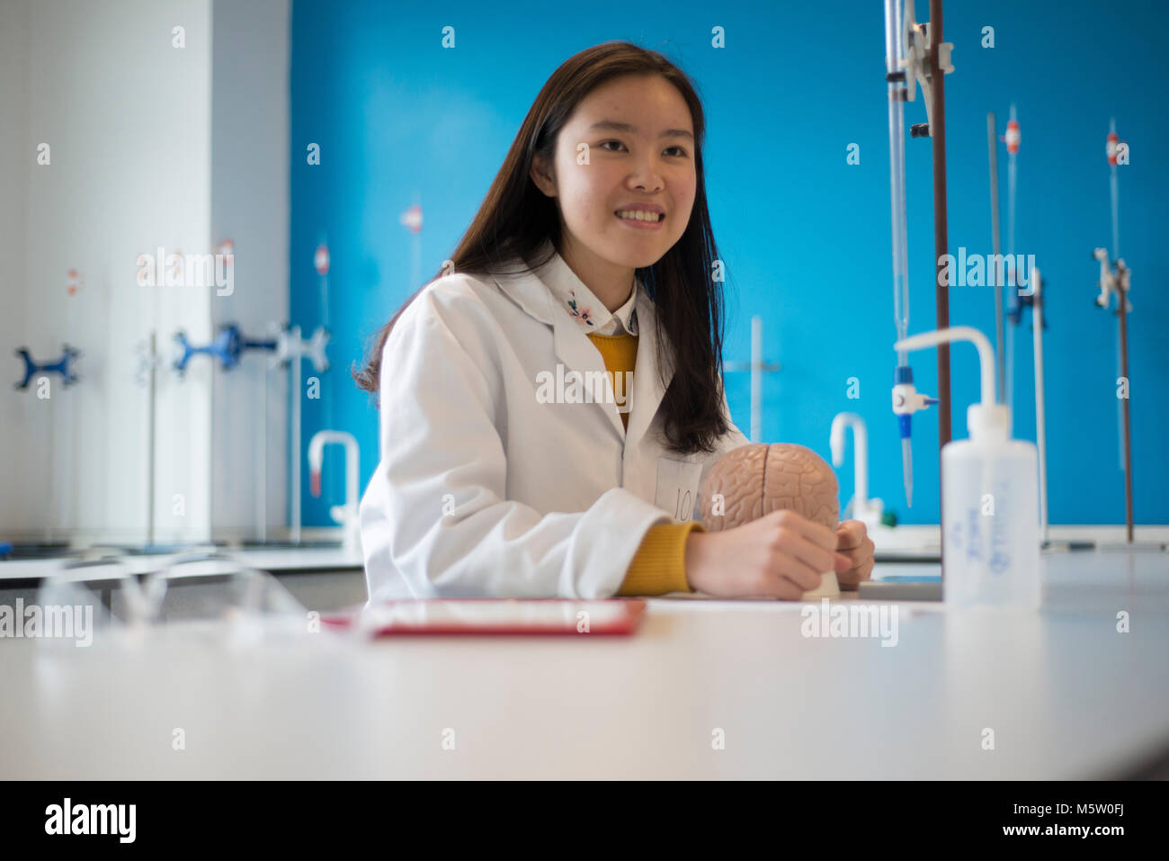 a young international asian student is photographed in the science lab ...