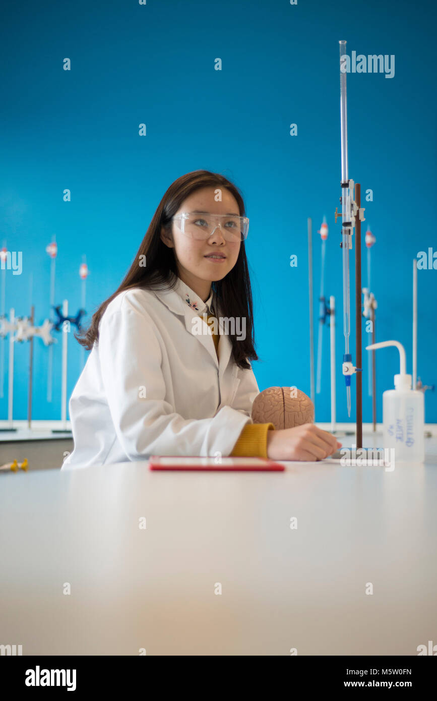 a young international asian student is photographed in the science lab ...
