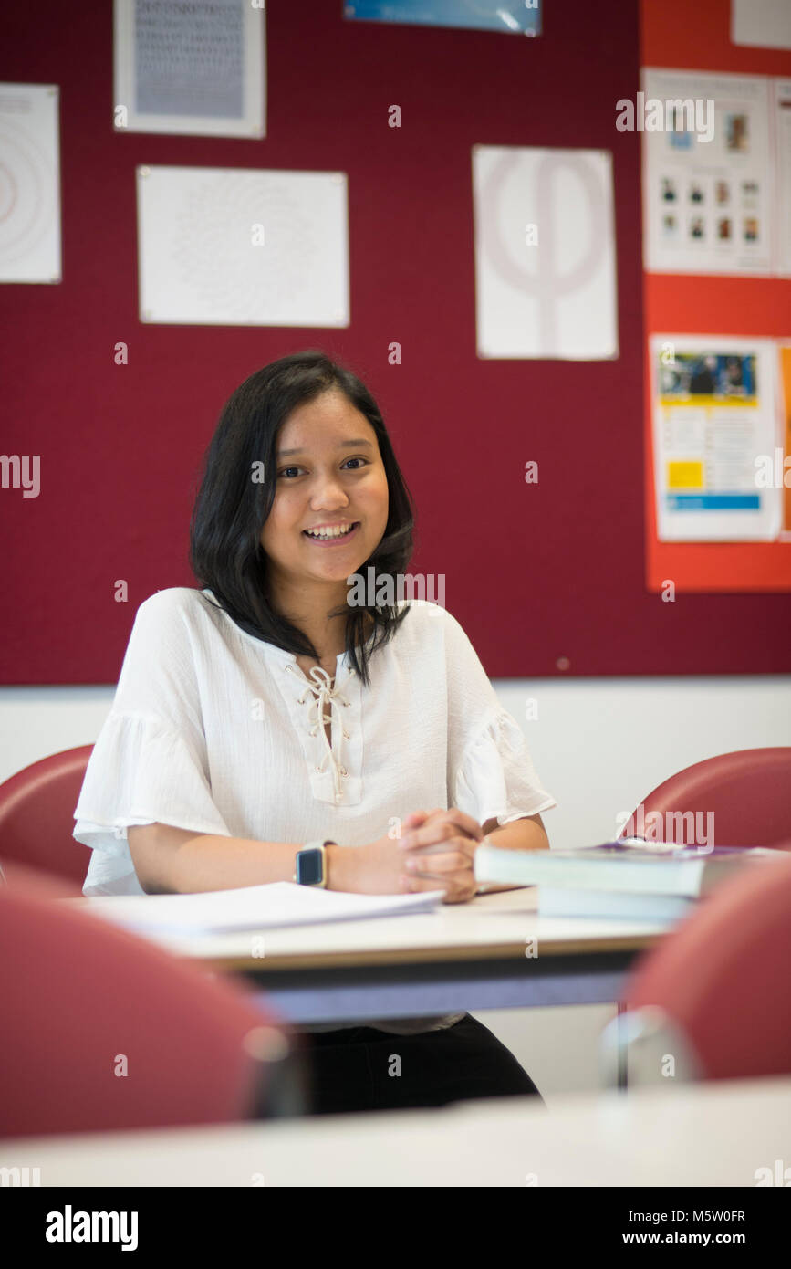 a young international asian english student in her classroom at college ...