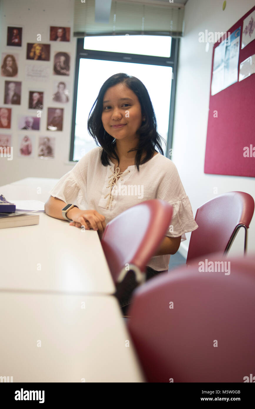 a young international asian english student in her classroom at college ...