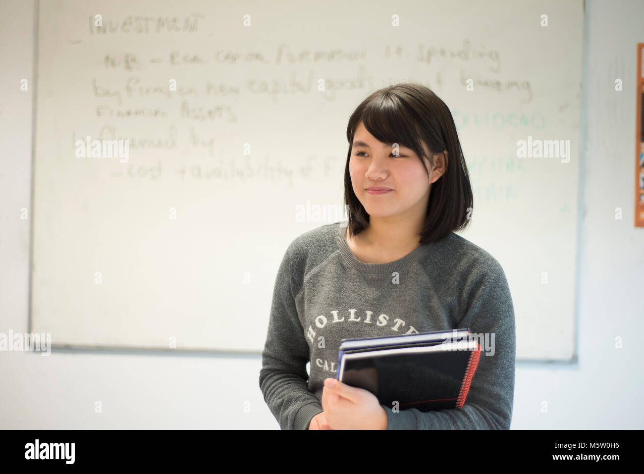 a young international asian english student in her classroom at college ...