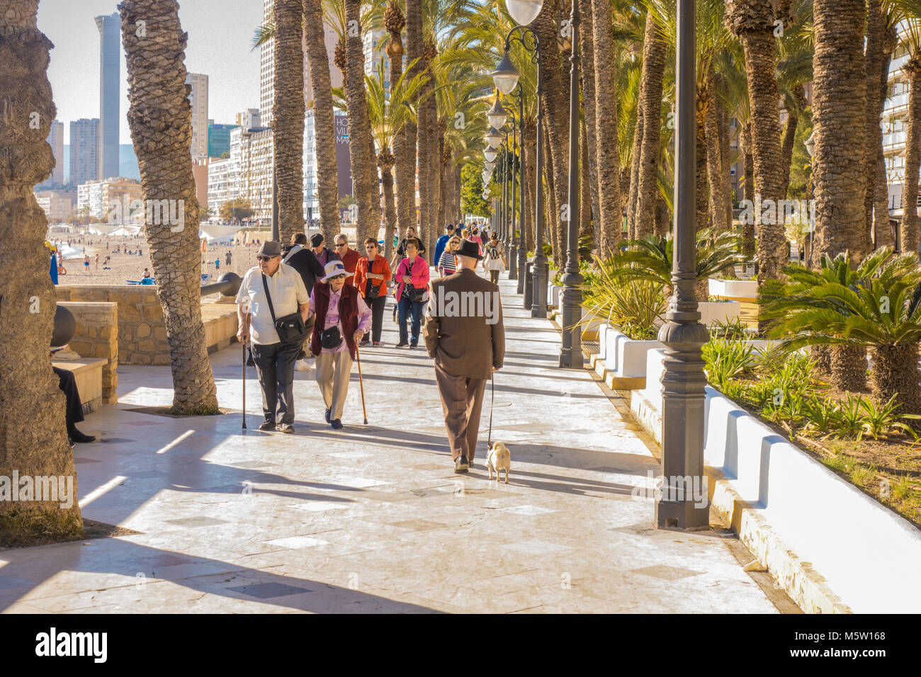 Eldery people walking on the embankment street in Benidorm, Spain Stock ...