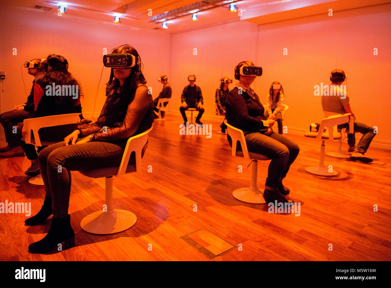 real people use an interactive virtual reality headset and head phones ...