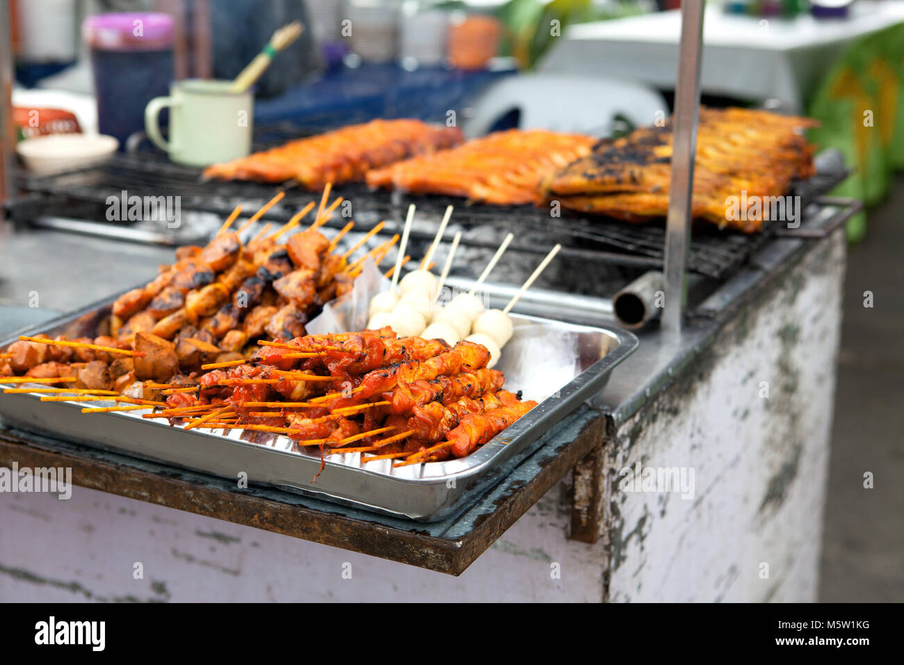 Grilling chicken at street food vendor market in Kota Kinabula, Borneo ...