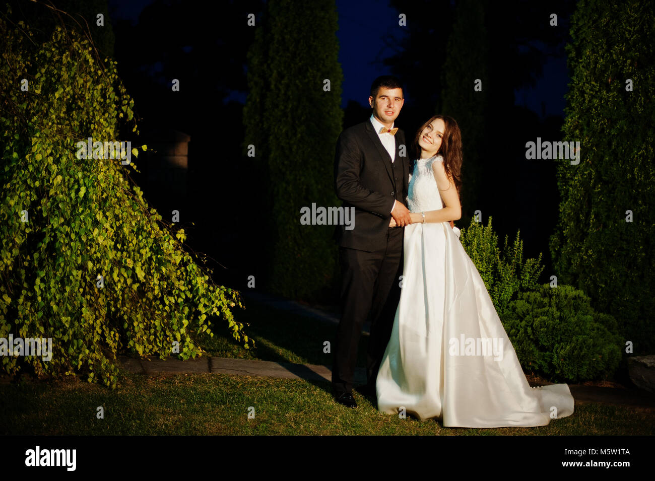 Wedding couple hugs at evening in love Stock Photo - Alamy
