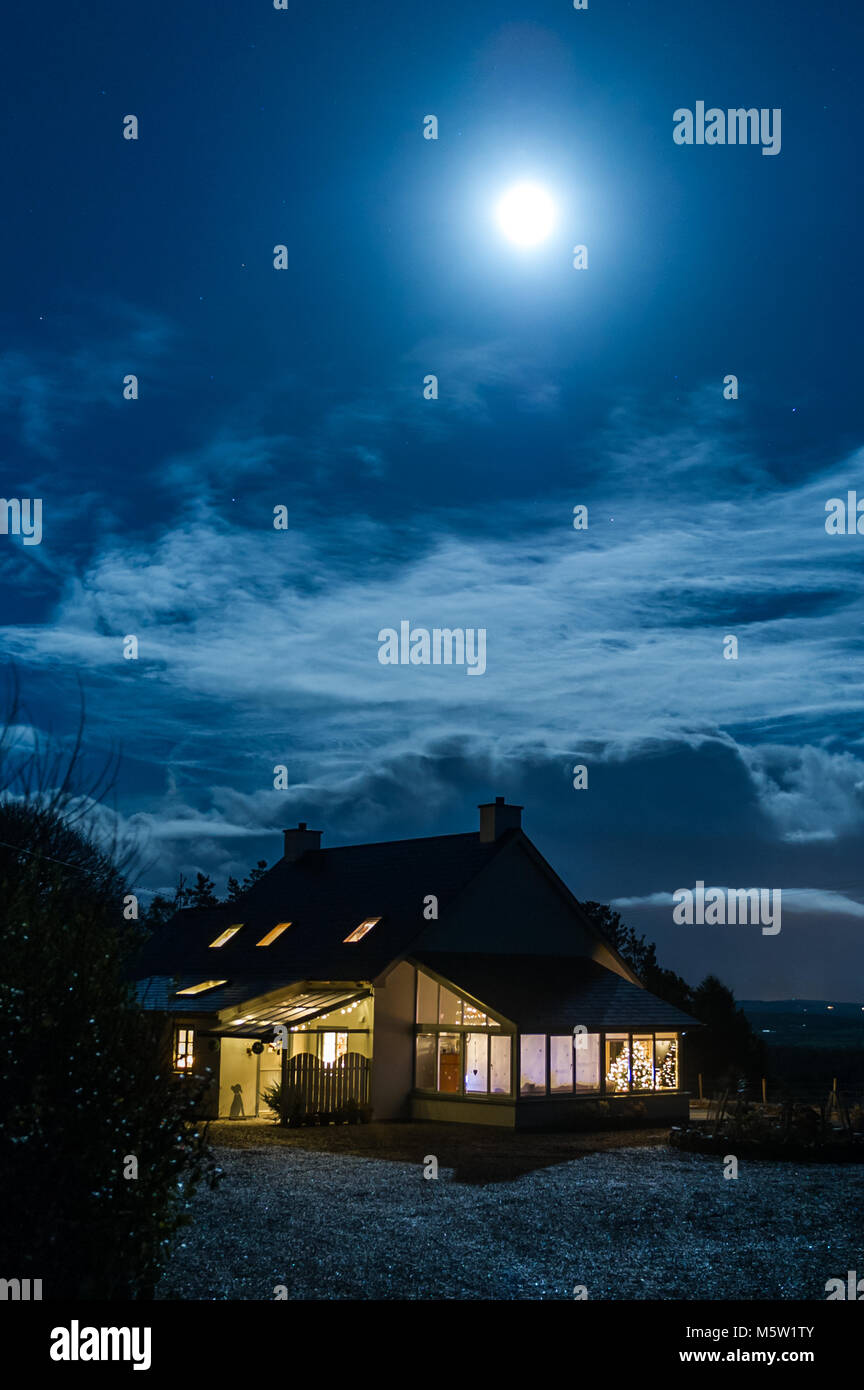 Country house illuminated by moonlight on Christmas Eve in Ballydehob ...