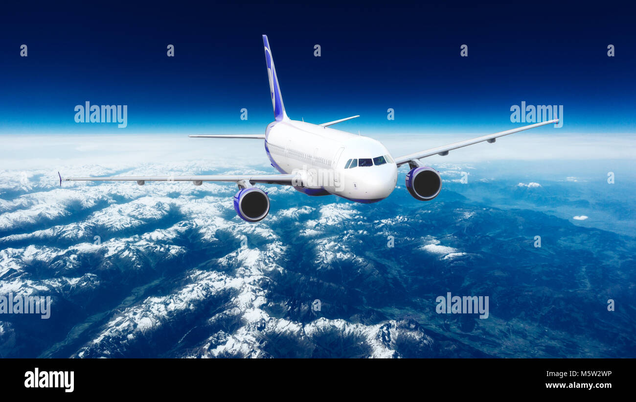 Flying of a passenger plane over the land Stock Photo - Alamy
