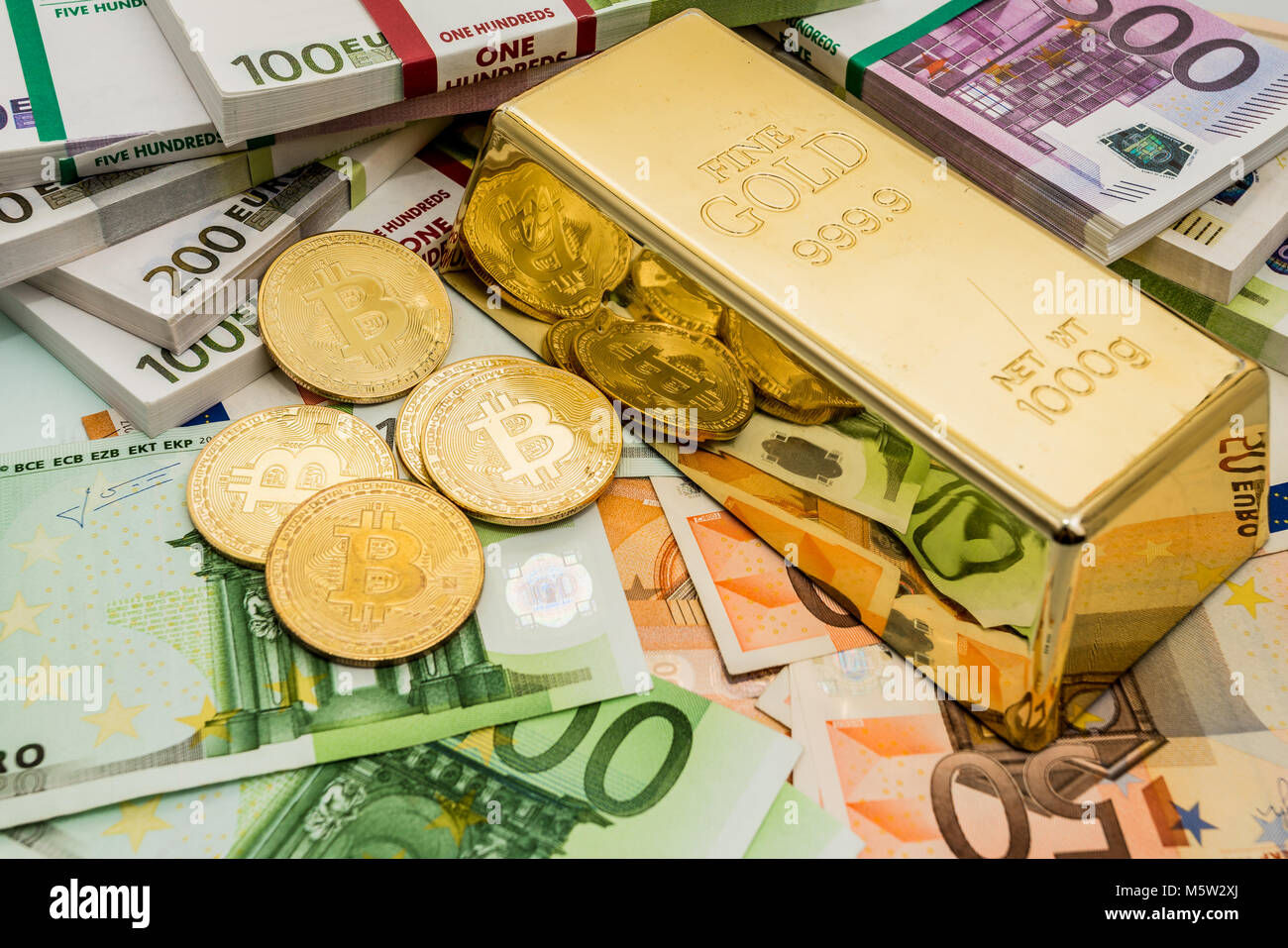 golden bitcoins with euro as a background with gold bar Stock Photo - Alamy