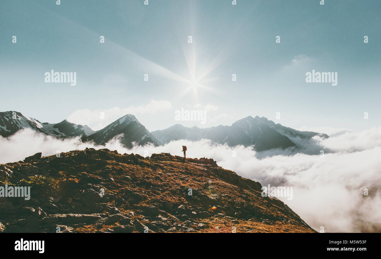 Traveler in mountains clouds landscape Travel lifestyle adventure ...