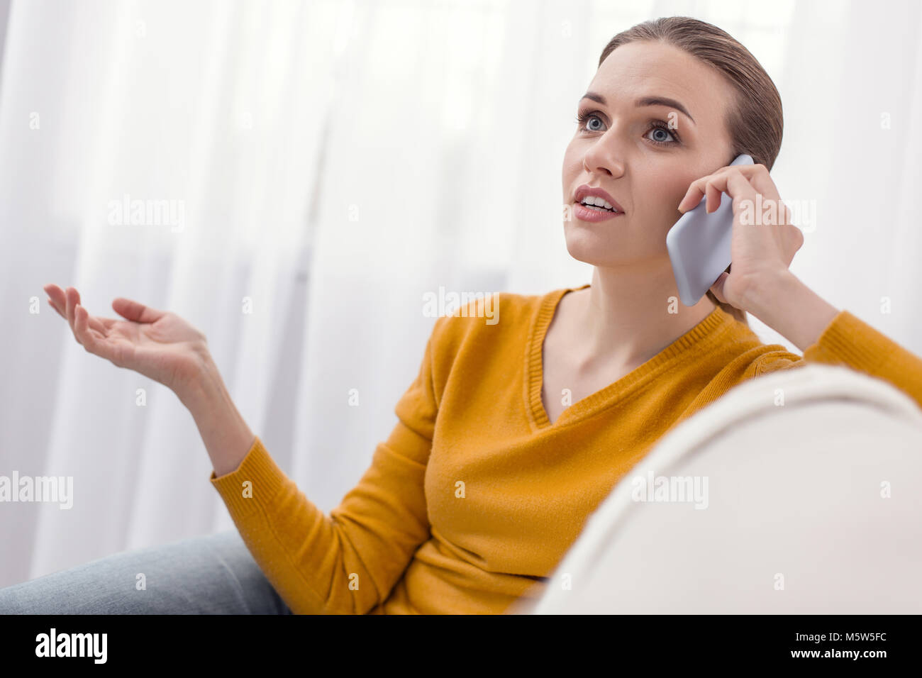 Inspired wondered woman making call Stock Photo - Alamy