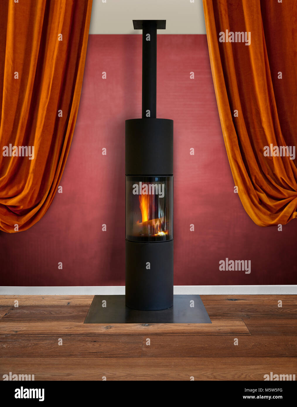 Modern interior with modern wood burner against textured red wall Stock ...