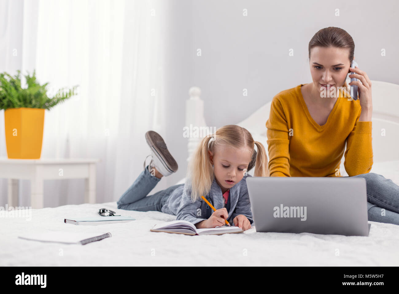 Young beautiful woman rising up girl alone Stock Photo - Alamy