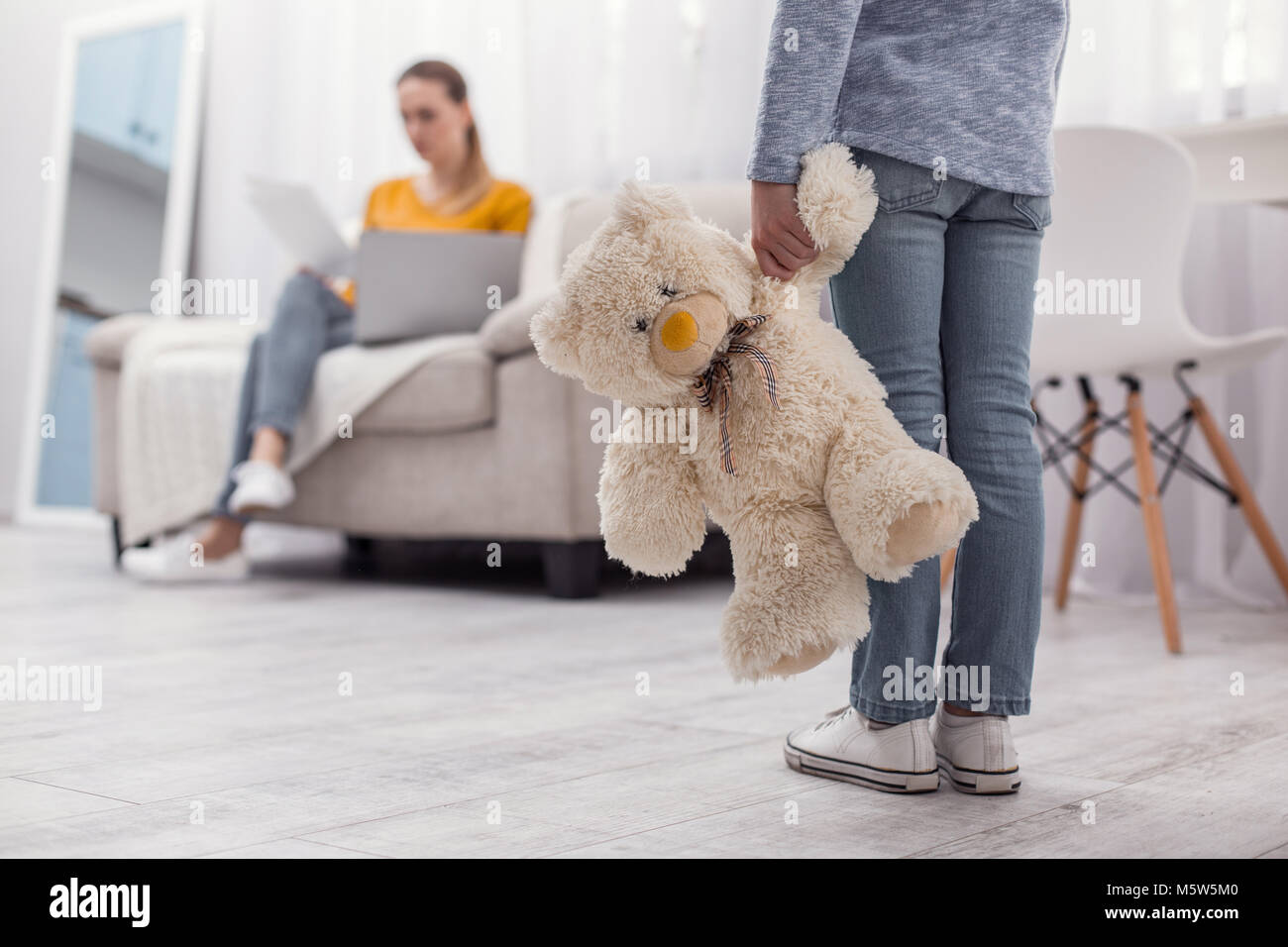Small child waiting for attention Stock Photo - Alamy