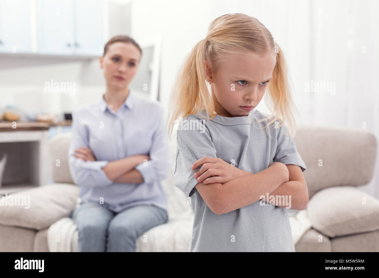 Upset mad girl grumping at mom Stock Photo - Alamy