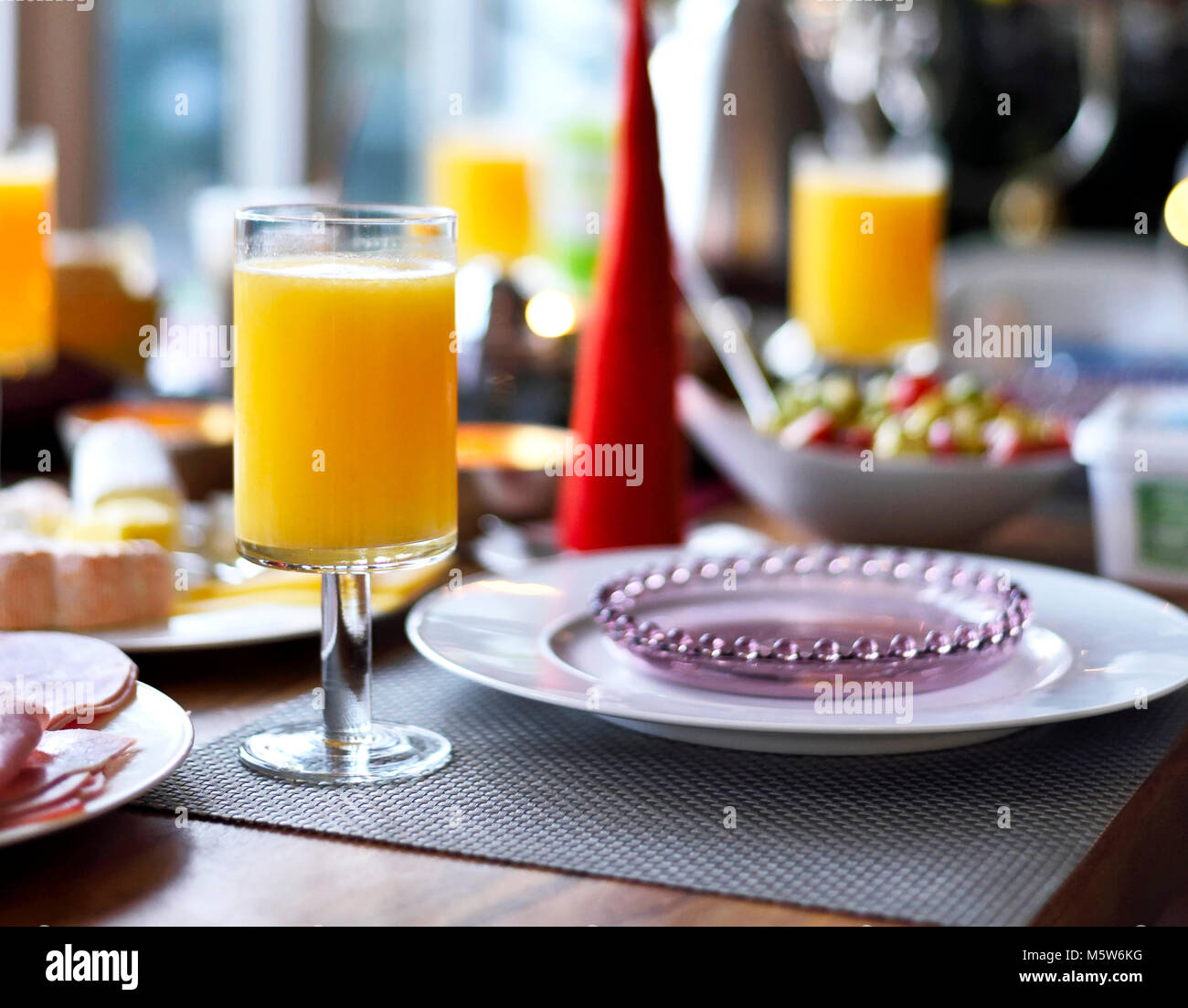 Breakfast scene with fresh orange juice and table setting. Breakfast ...