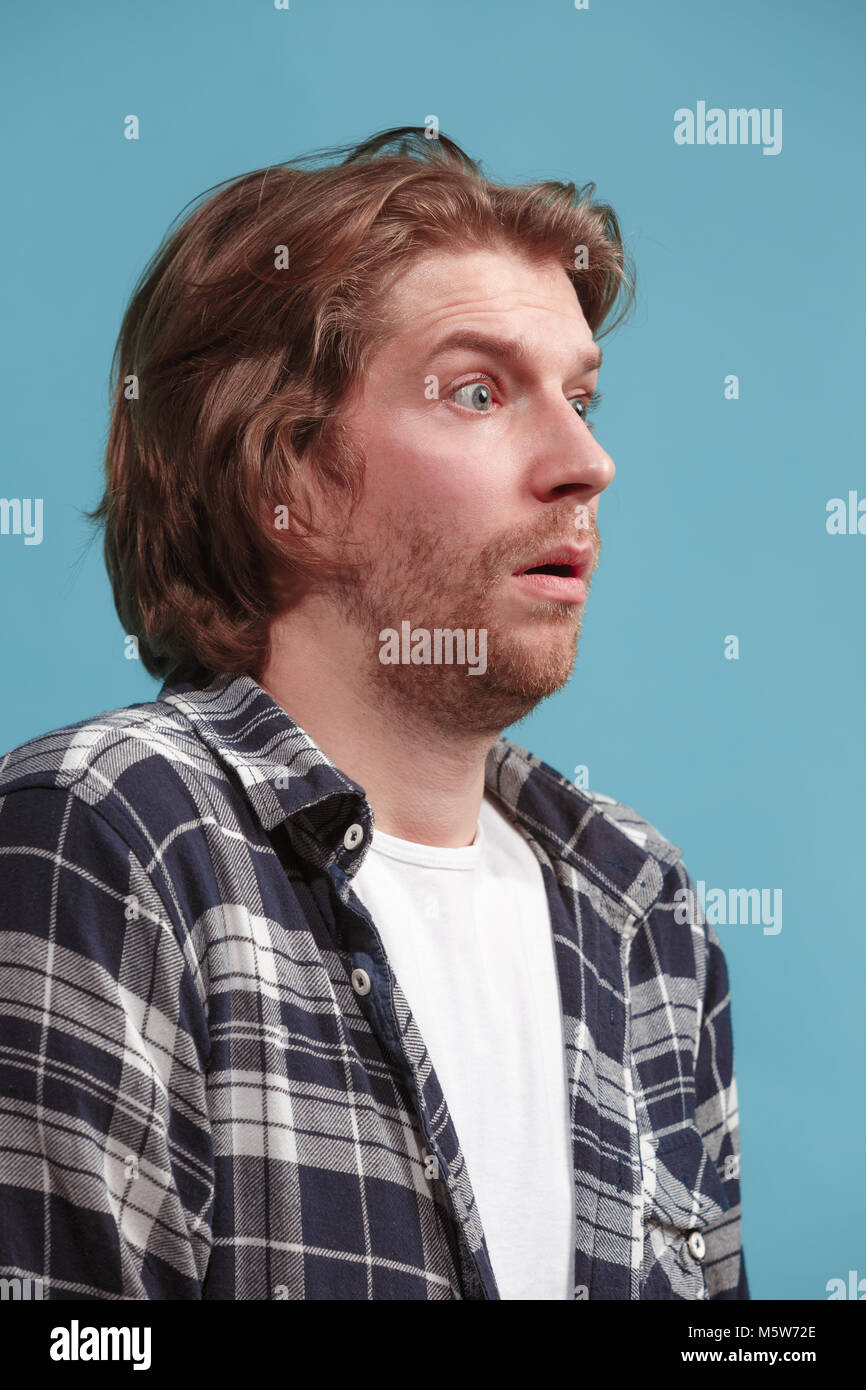 Beautiful man in stress isolated on blue Stock Photo - Alamy