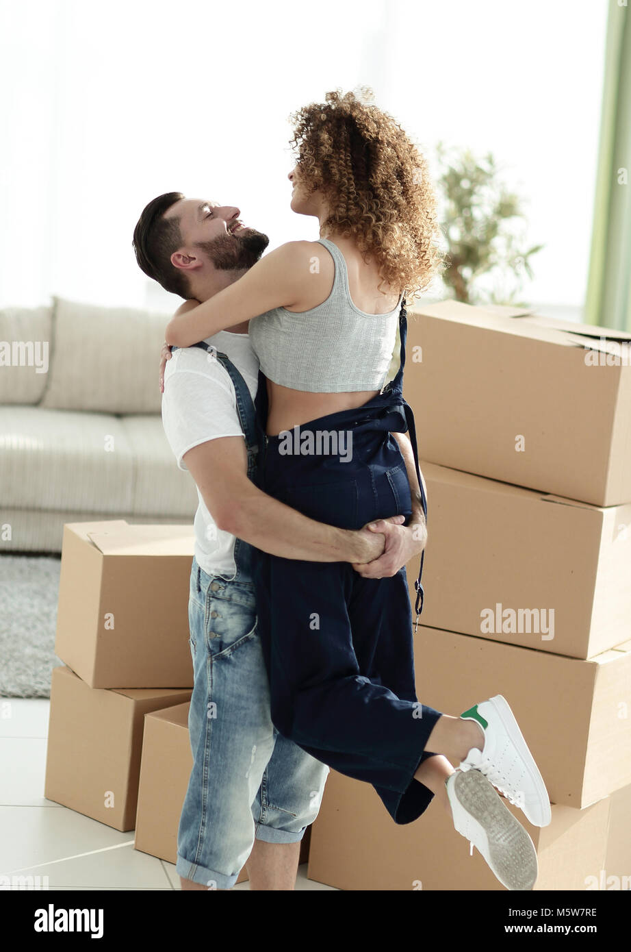 Hugging couple, against the background of boxes Stock Photo - Alamy