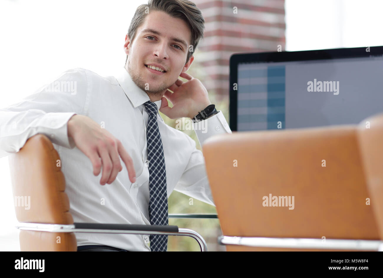 employee sitting in front of a computer screen Stock Photo - Alamy