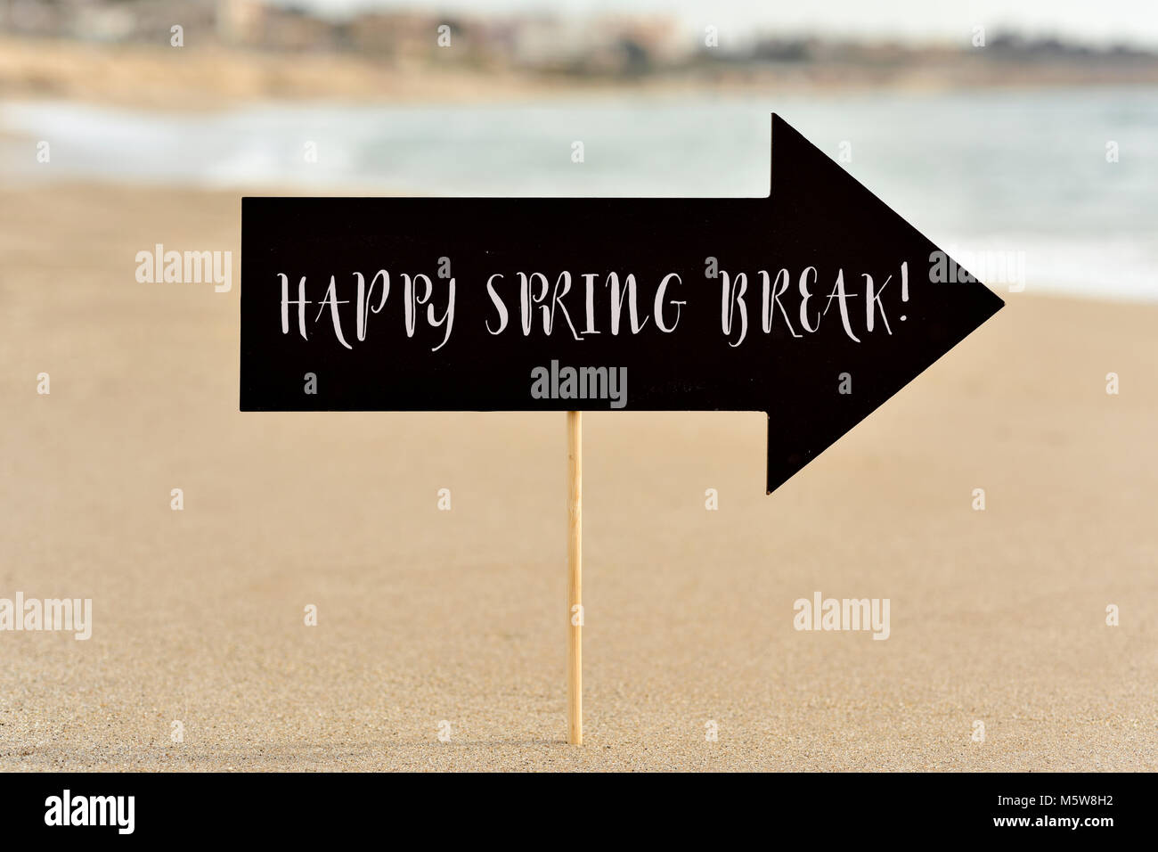 an arrow-shaped signboard with the happy spring break written in it, on ...