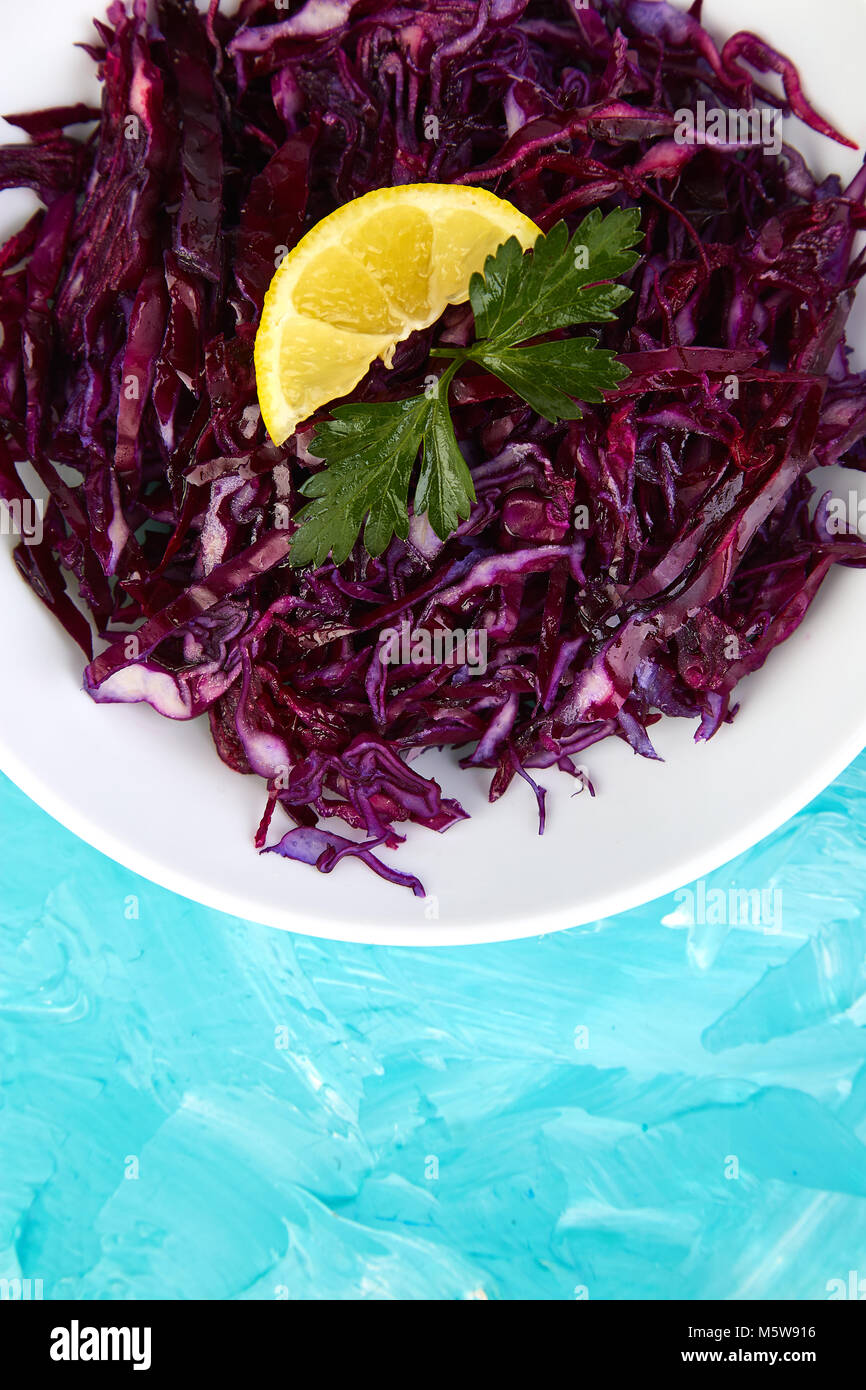 Shredded red cabbage in bowl on blue background. Vegetarian healthy ...