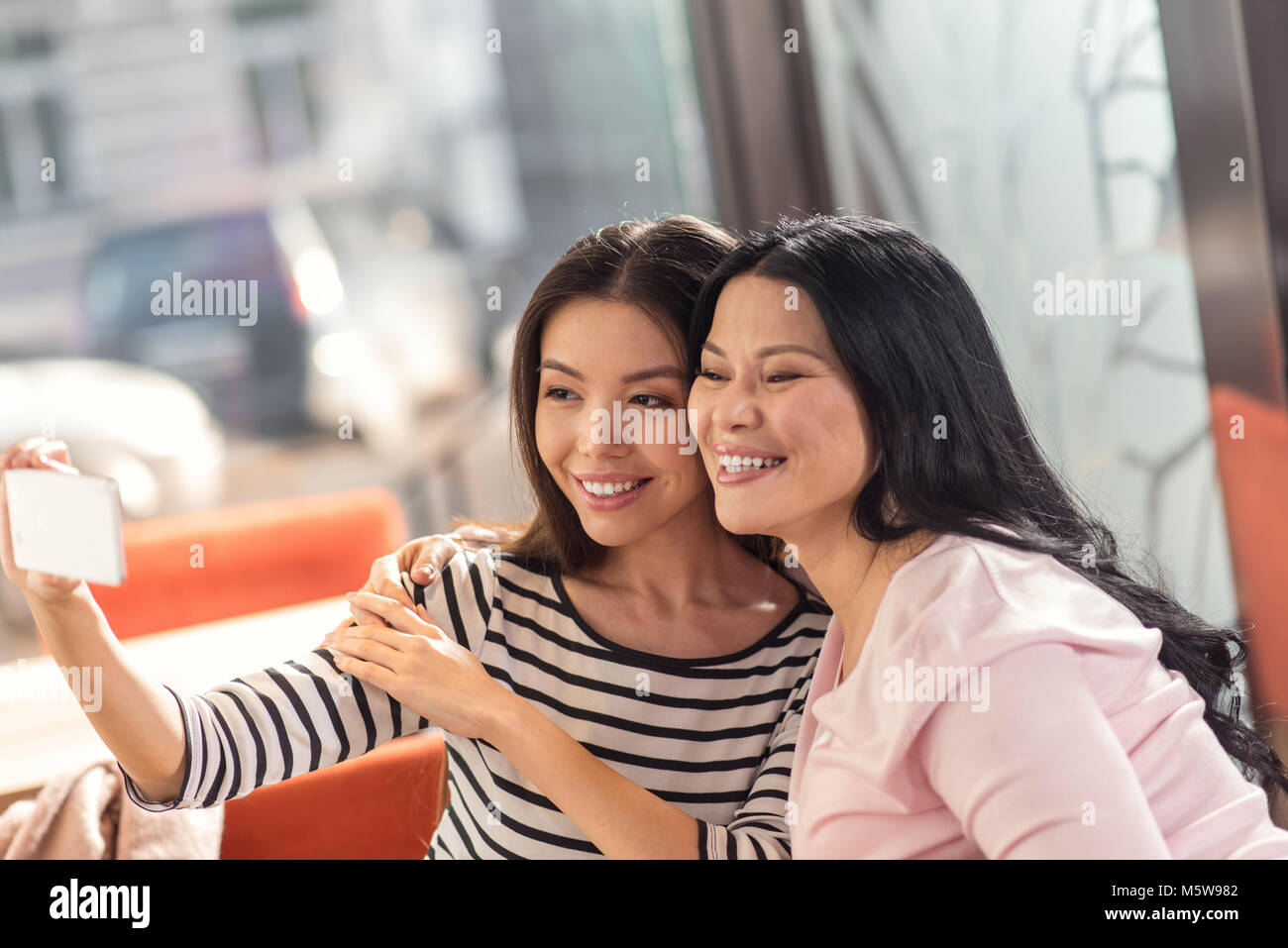Cheerful positive women smiling Stock Photo - Alamy