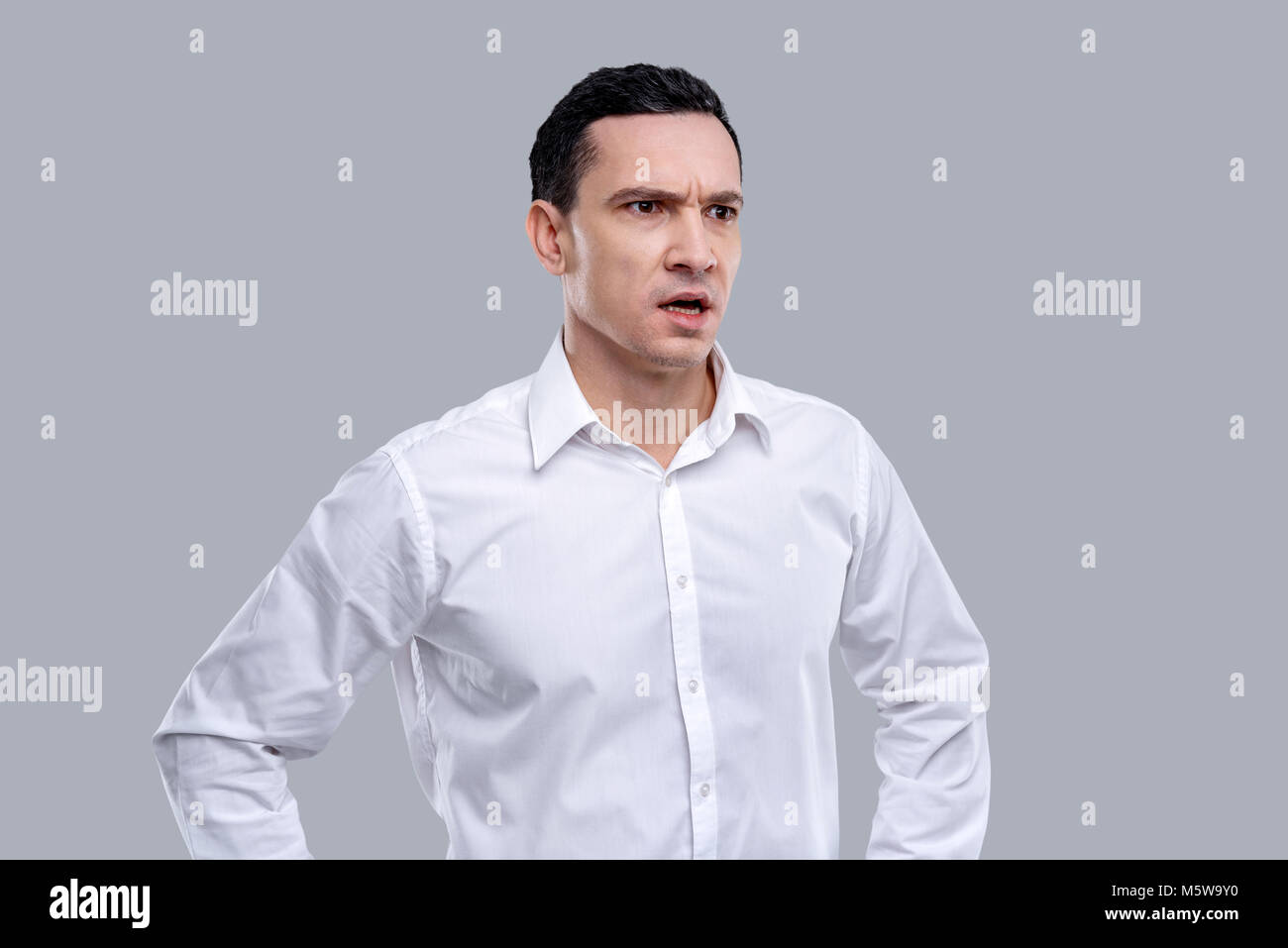 Firm young man looking strictly Stock Photo - Alamy