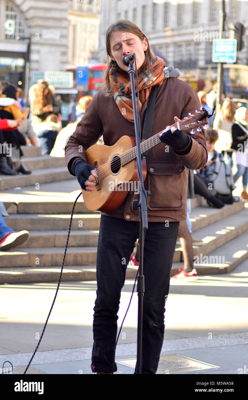 Male outdoor street entertainer with guitar Stock Photo - Alamy