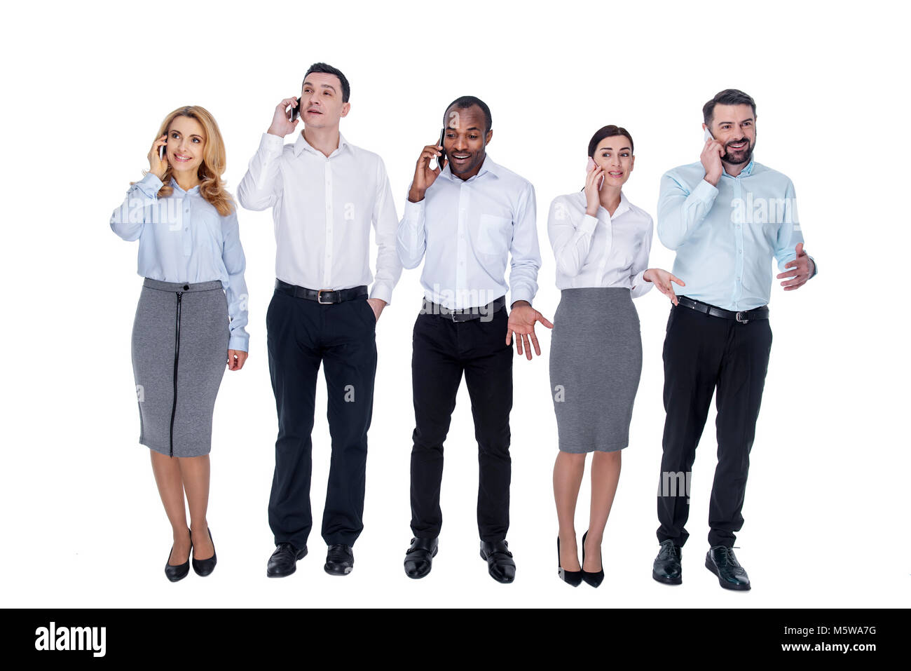 Smiling co-workers talking on the phones about work Stock Photo - Alamy