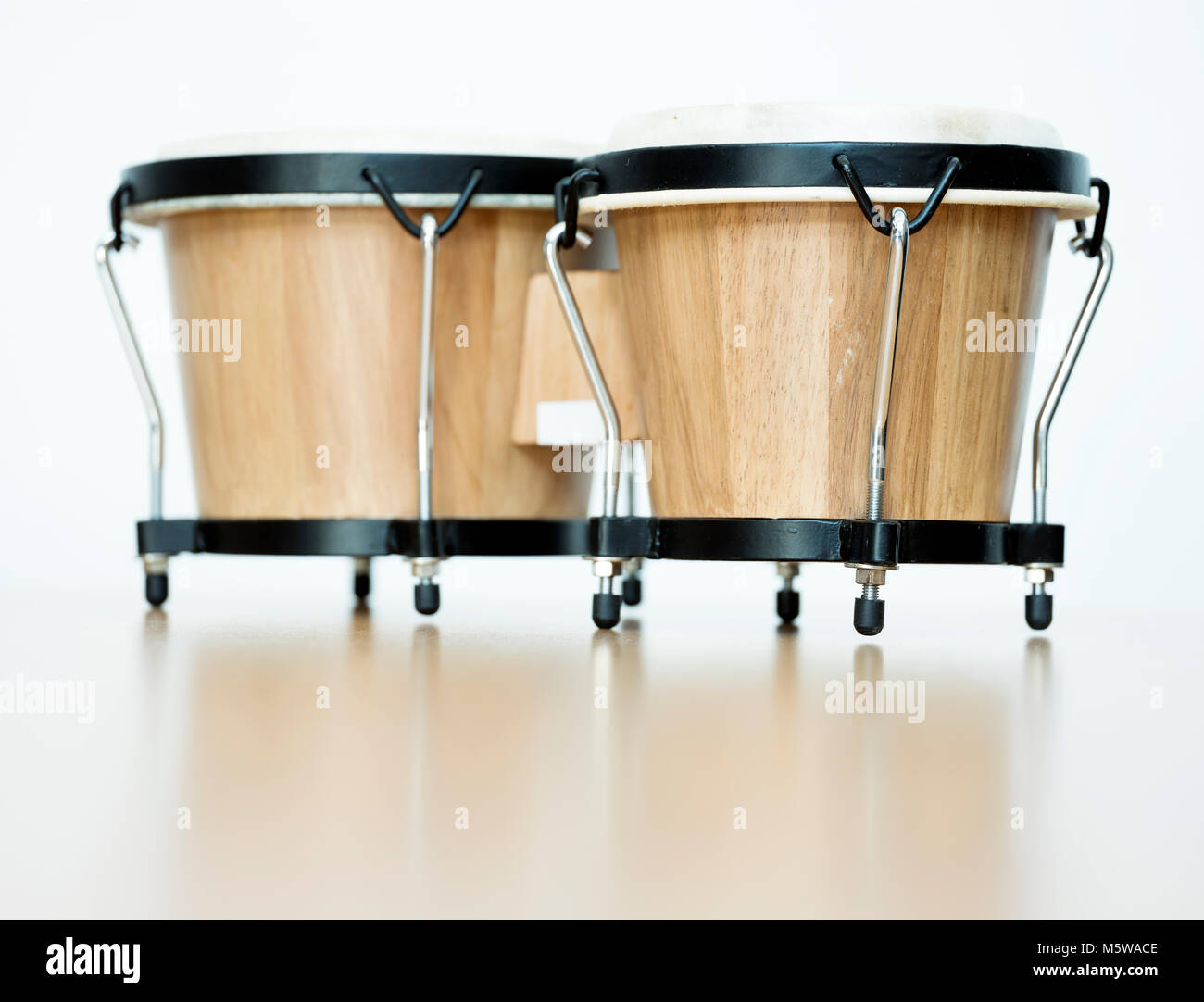 pair of bongos on reflecting surface in studio Stock Photo - Alamy