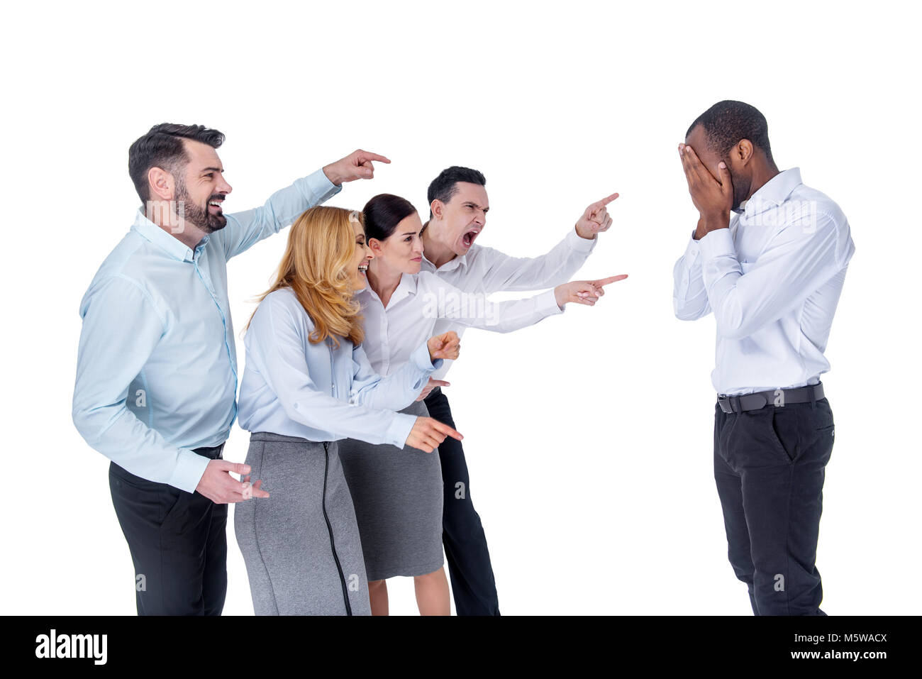 Wicked colleagues mocking at their co-worker Stock Photo - Alamy