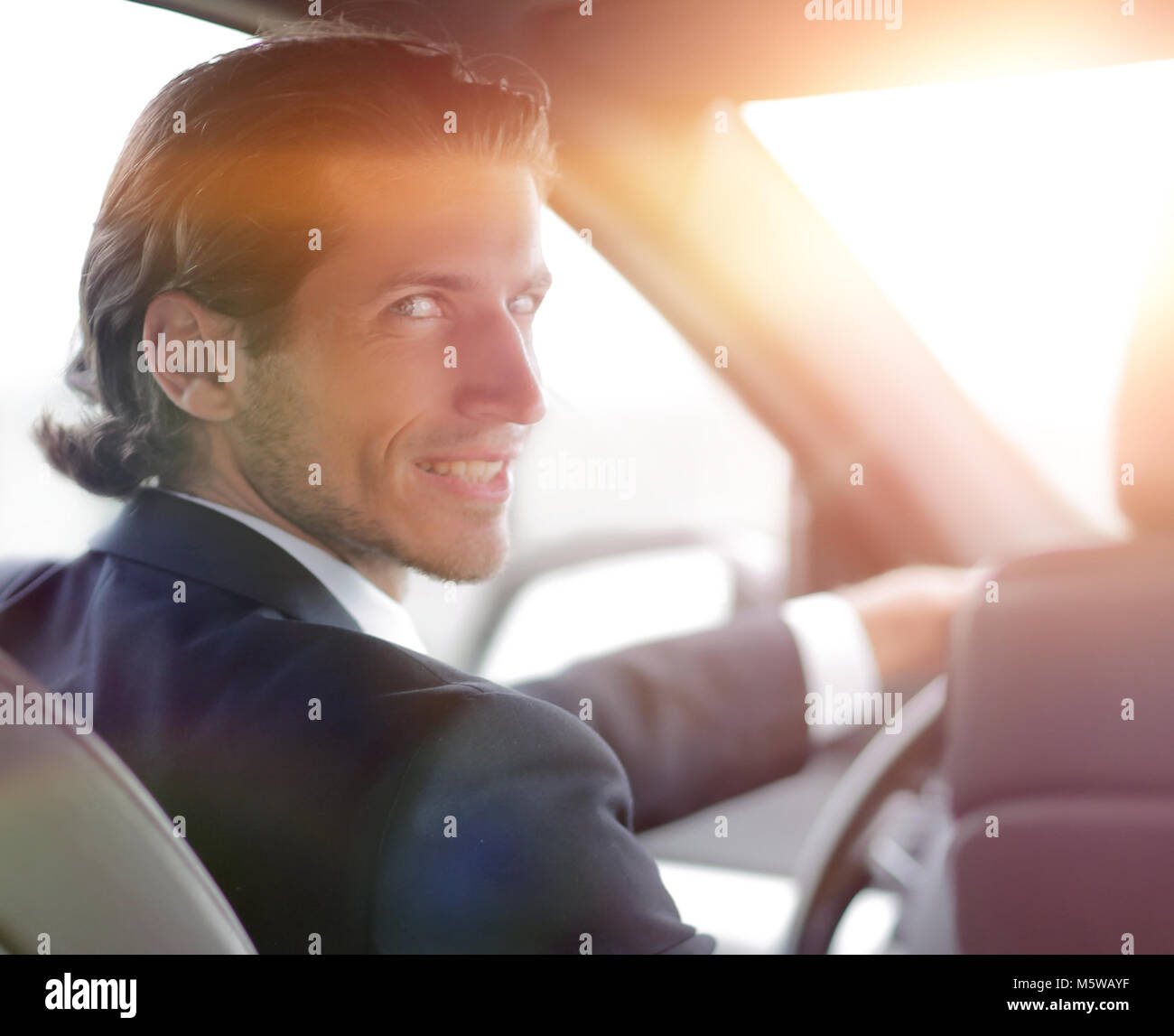 man sitting behind the wheel of a car Stock Photo - Alamy