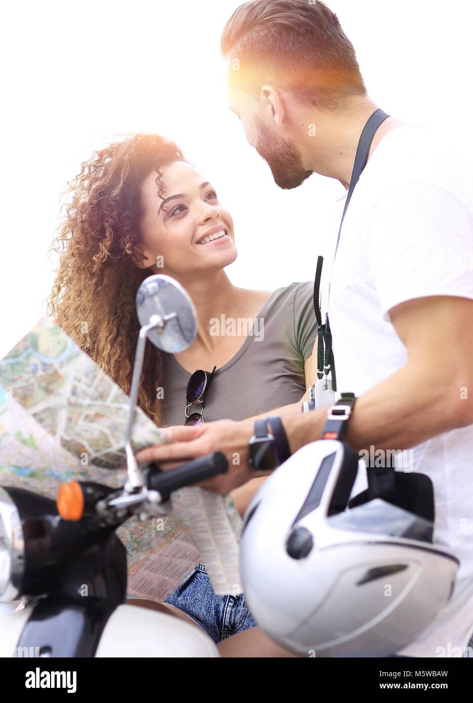 Couple riding motor scooter in old city street Stock Photo - Alamy