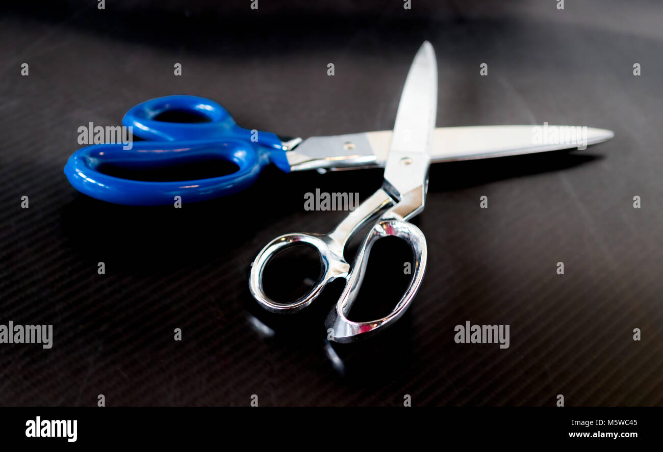 Stainless steel shears crossed on a carbon fiber table Stock Photo - Alamy