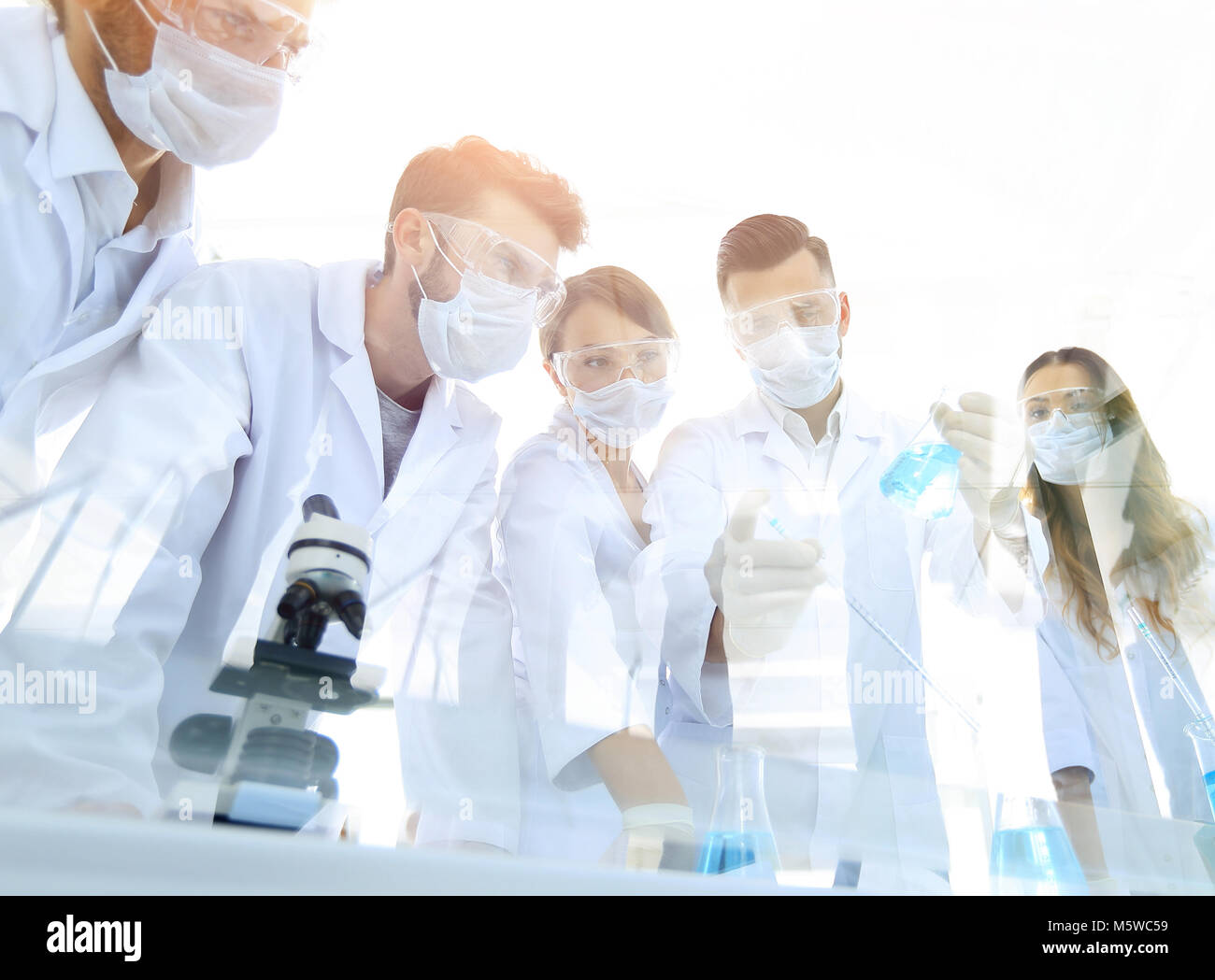 scientists working with test tubes and microscope in the laborat Stock ...