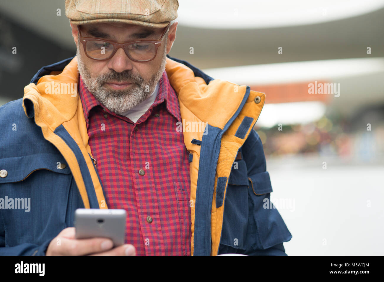 Adult man using smartphone application Stock Photo - Alamy