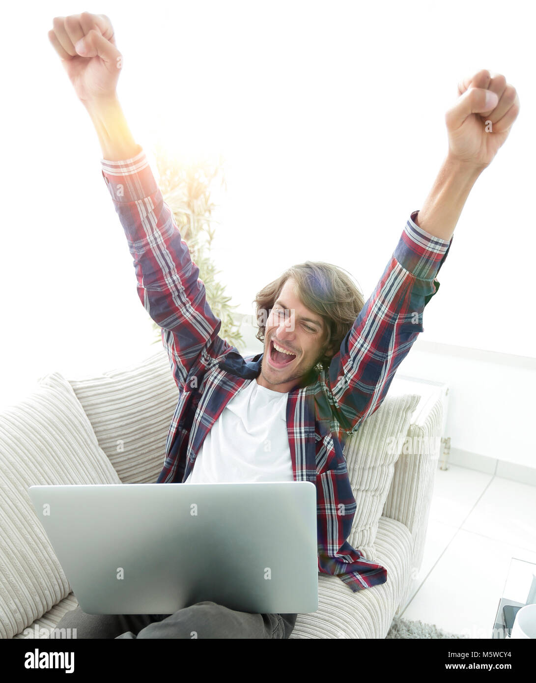 very happy guy working with laptop at home Stock Photo - Alamy