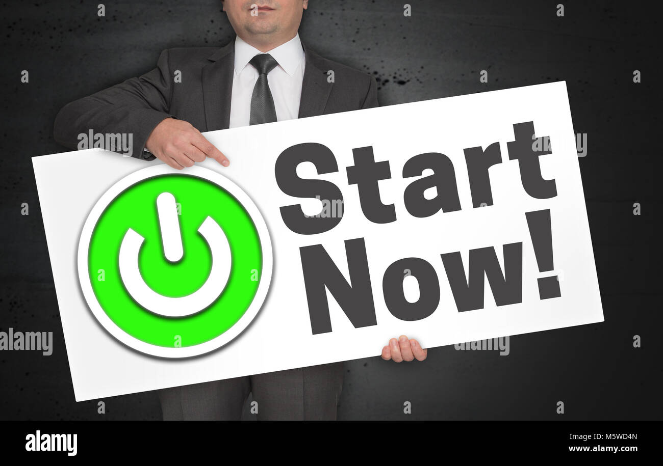 Start Now poster is held by businessman Stock Photo - Alamy