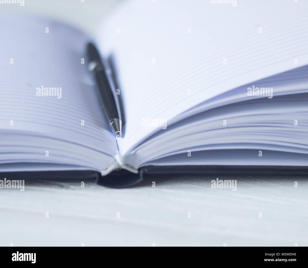 pen and a notebook at the workplace Stock Photo - Alamy