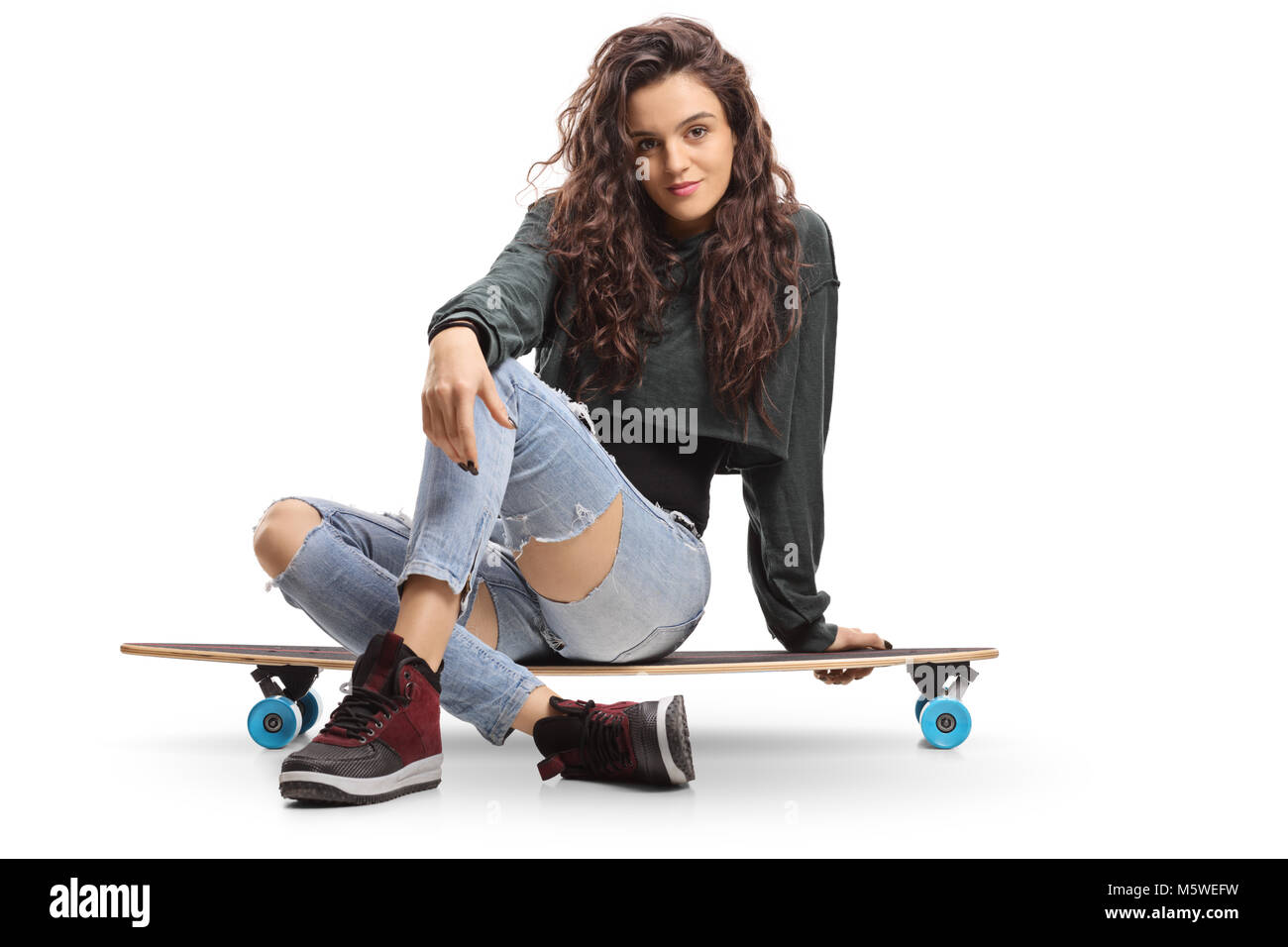 Skater girl sitting on a longboard isolated on white background Stock ...