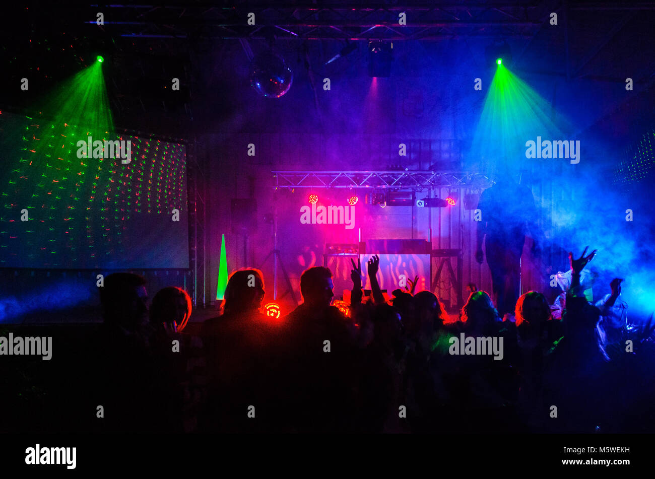 People Celebrating a Party, dancing, lots of colored light Stock Photo ...