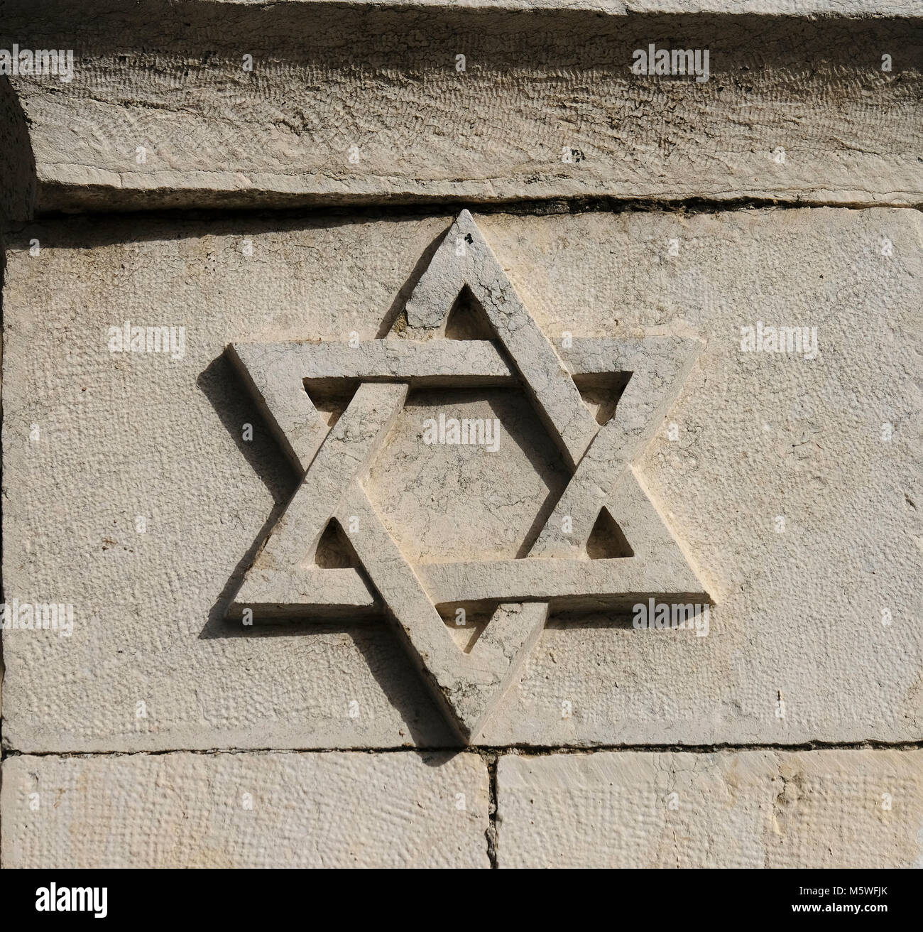 A Jewish Star of David relief on a side post at the entrance to a house ...