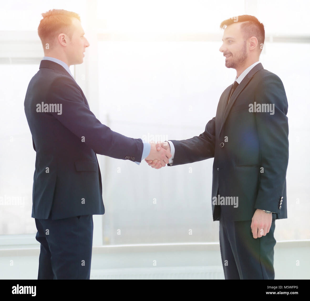 handshake financial partners in the corridor of the office Stock Photo ...