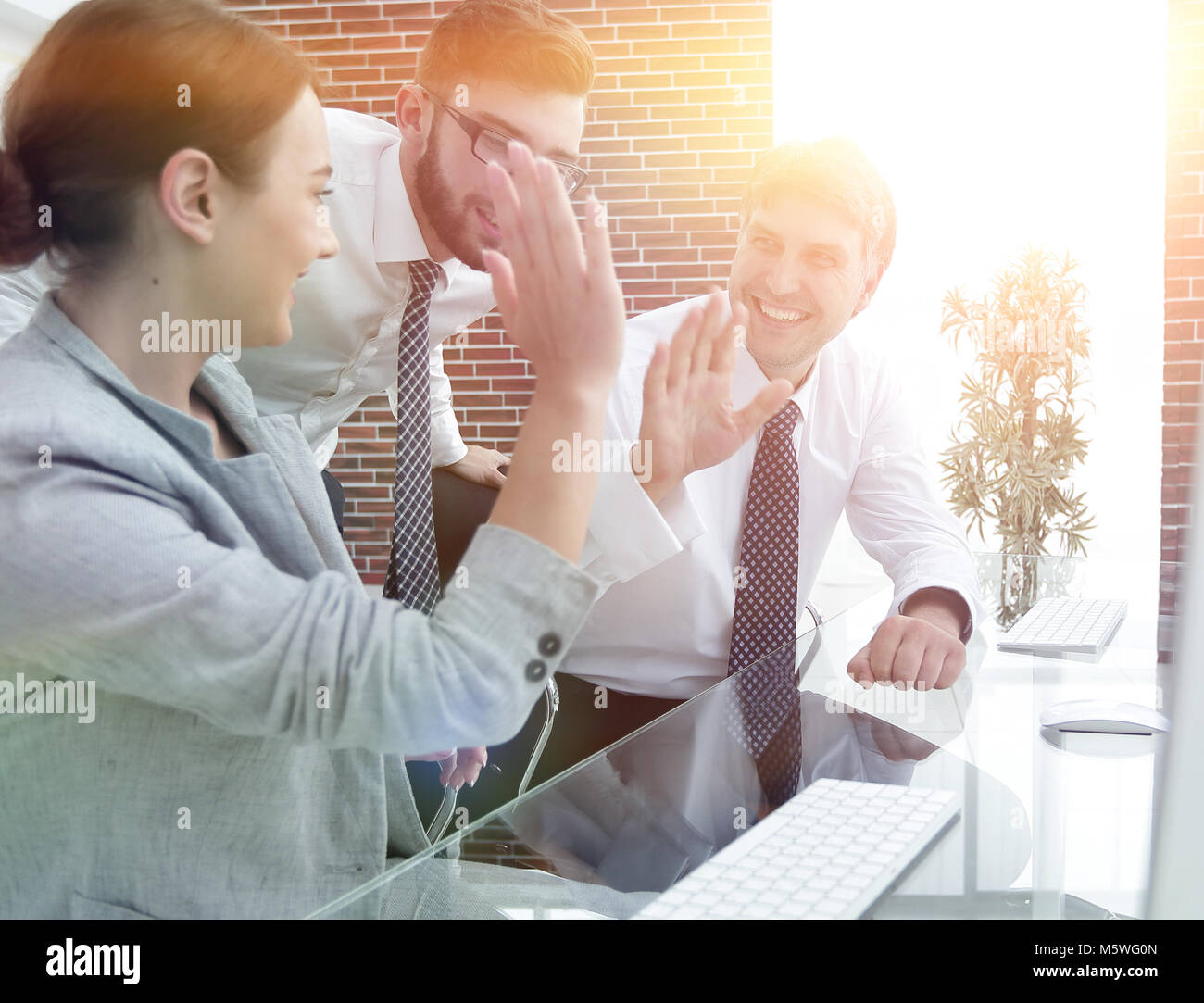 Friendly business team shows its success Stock Photo - Alamy
