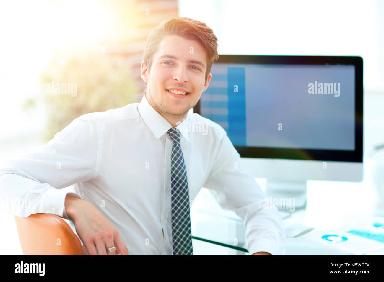 employee sitting in front of a computer screen Stock Photo - Alamy