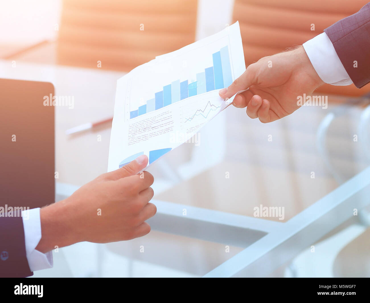 Business people discussing financial graphs Stock Photo - Alamy