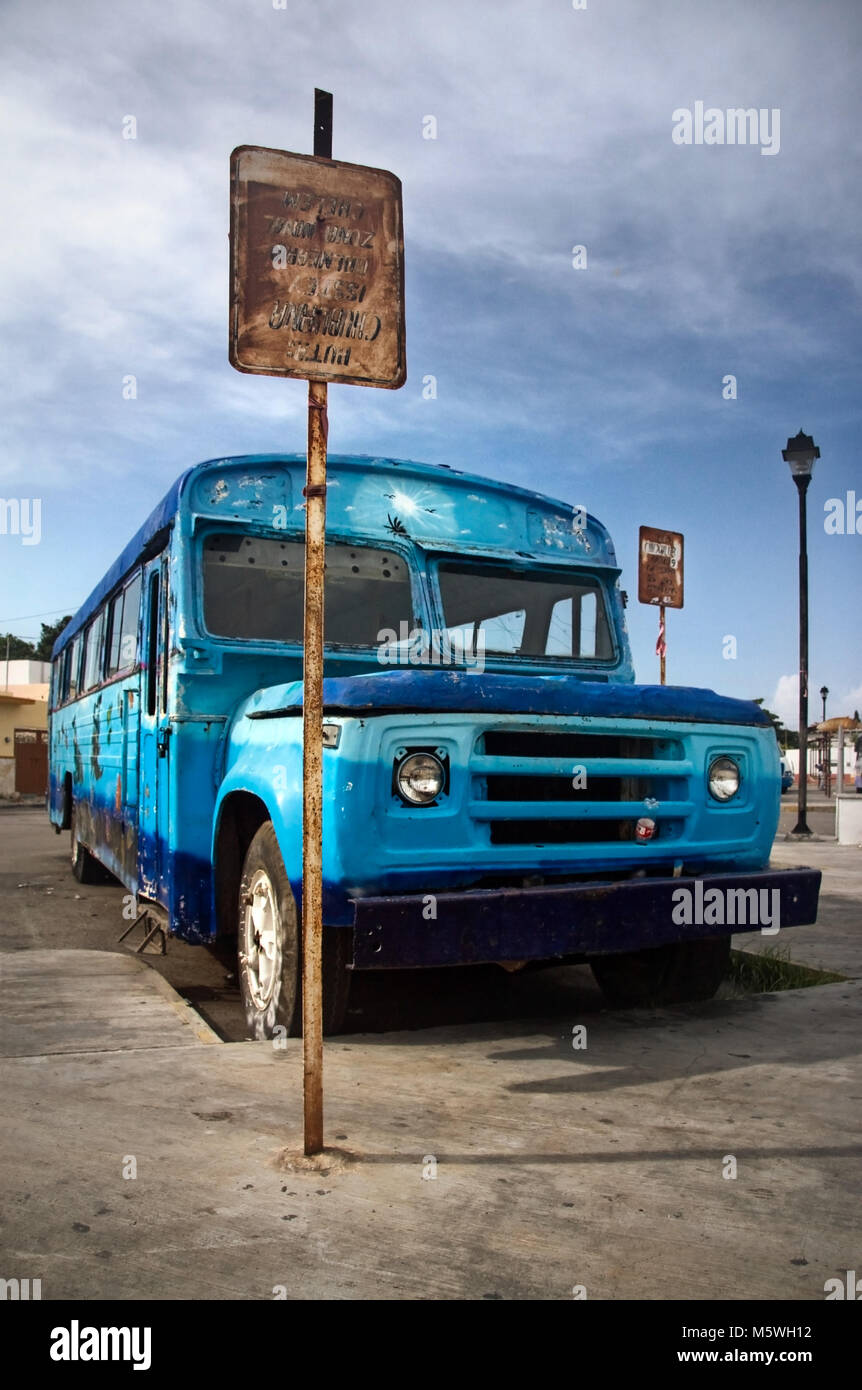 Rusty old blue coach standing next to bus stop Stock Photo - Alamy