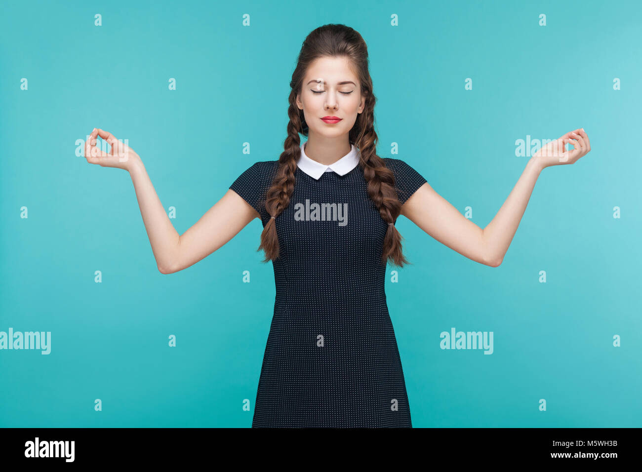 Meditating, zen practice. Young woman doing yoga. Indoor, studio shot ...