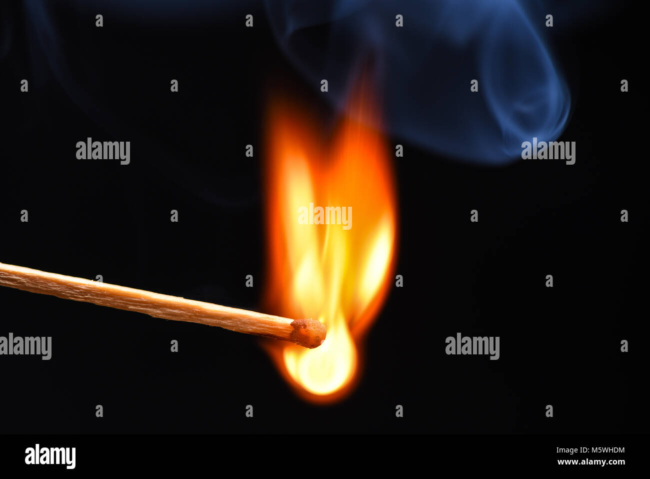 Burning match on a black background Stock Photo - Alamy
